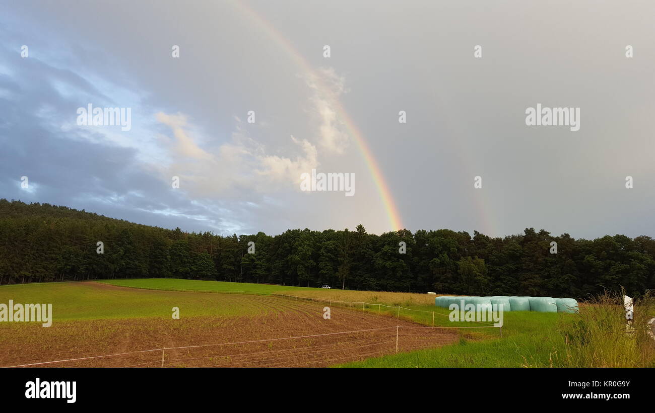 rainbow over a field Stock Photo - Alamy