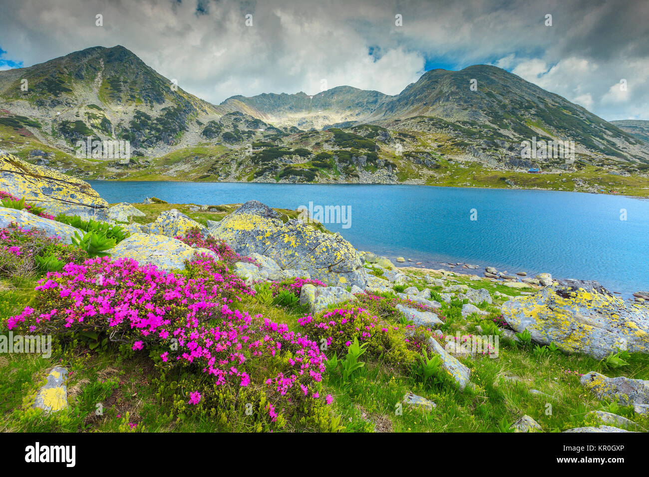 Magical alpine glacier lake, high mountains, cloudy sky and wonderful ...