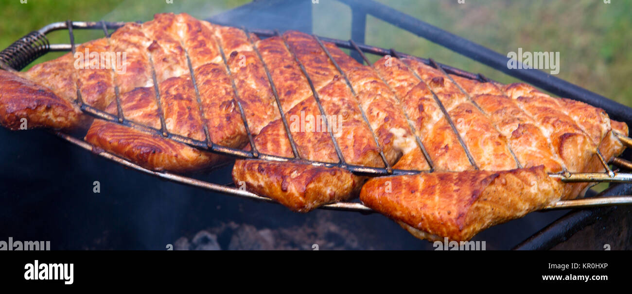 Grilled fish with spices on fire.Salmon fillet on the grill and flame ...