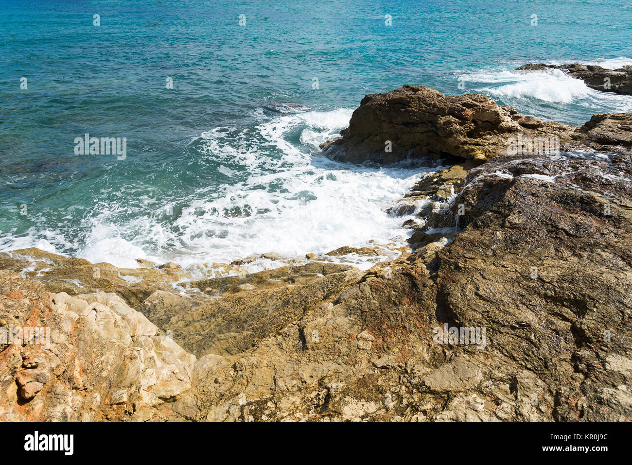 The waves breaking on a stony beach, forming a spray. Wave and splashes ...