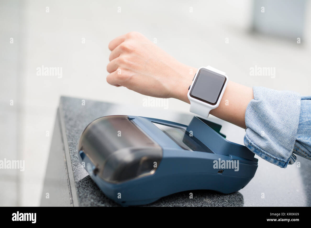 Female customer paying through smart watch Stock Photo - Alamy