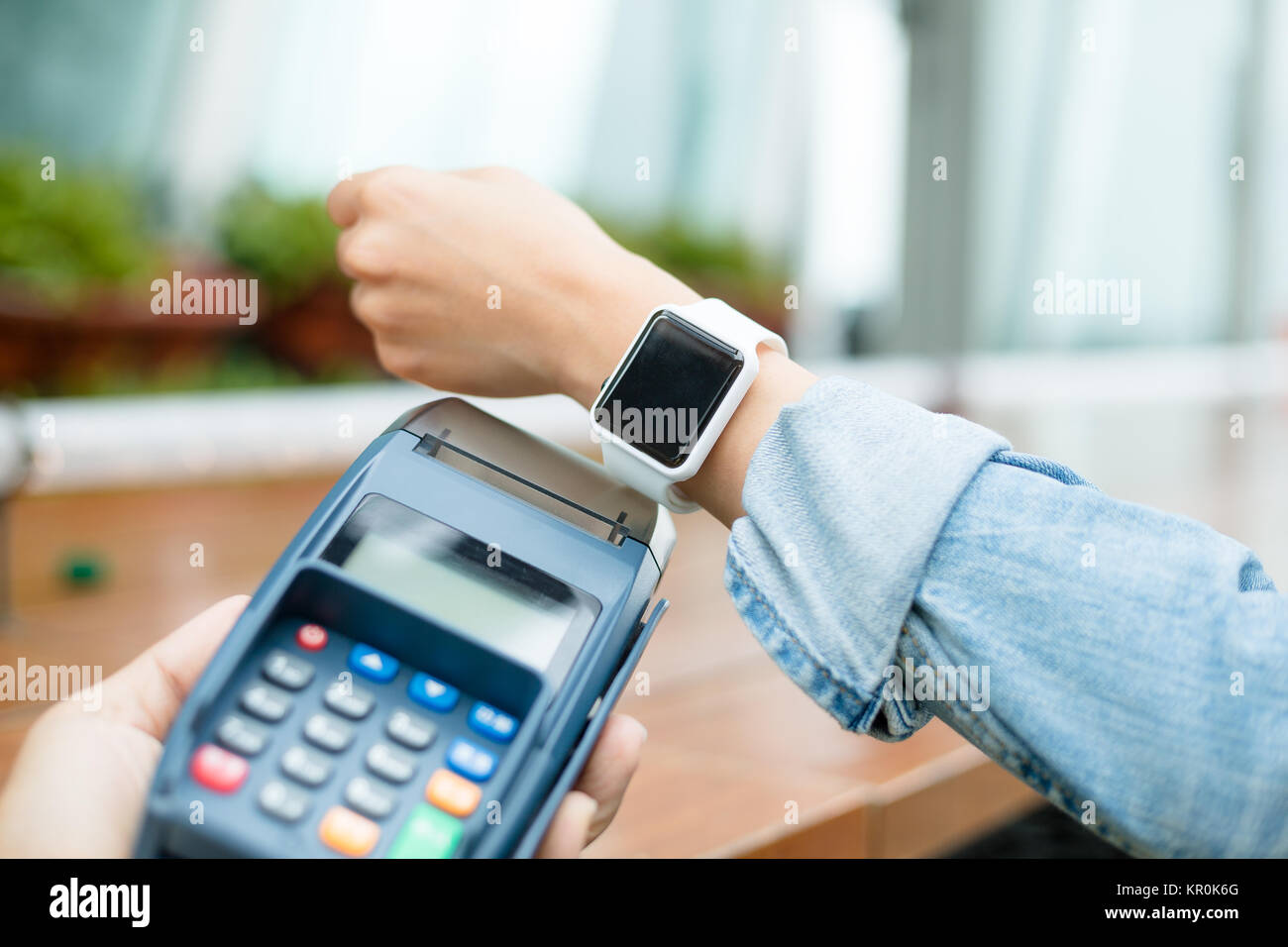 Customer paying through smart watch Stock Photo - Alamy