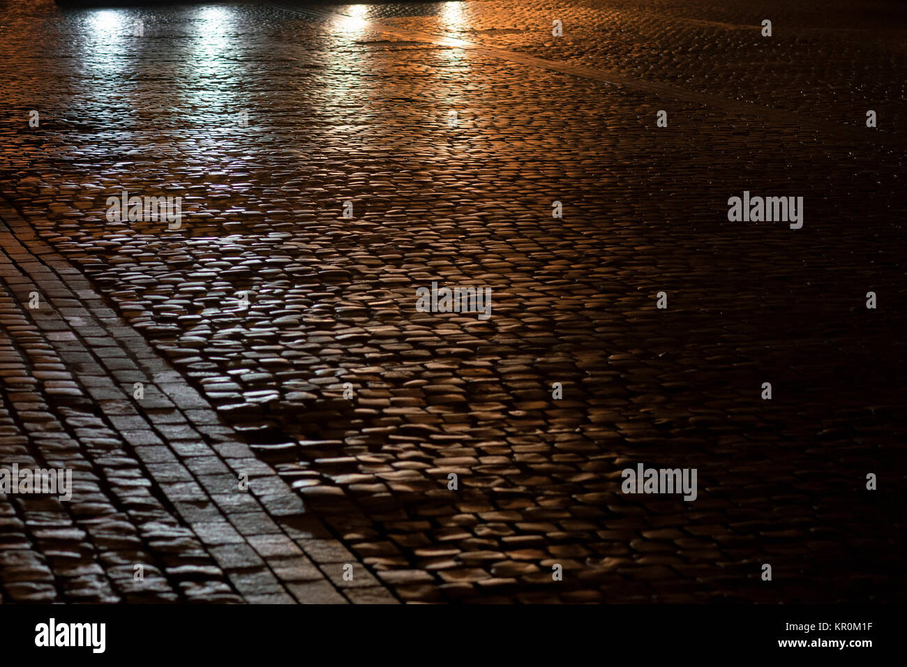 Glistening paving stone from the light of street lamps in the park ...