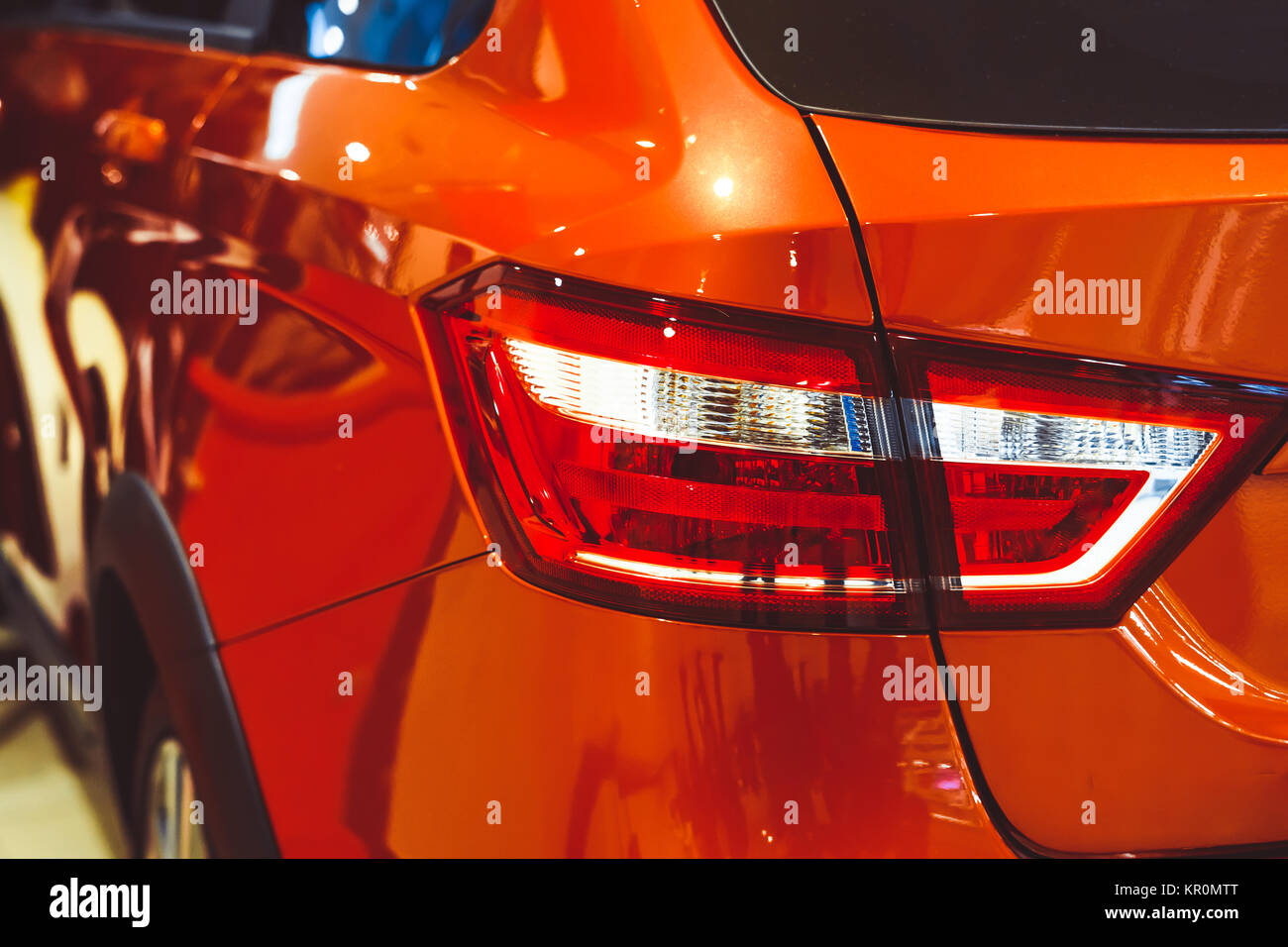 Modern blue car tail light in wet rain drop. Red modern car back light ...