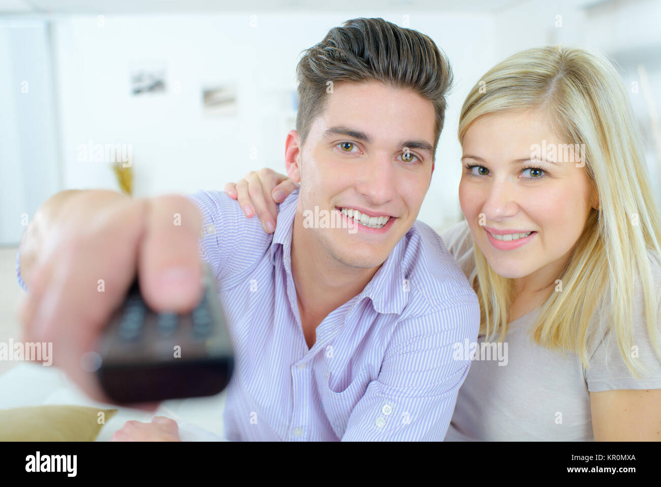 Couple using a remote control Stock Photo - Alamy