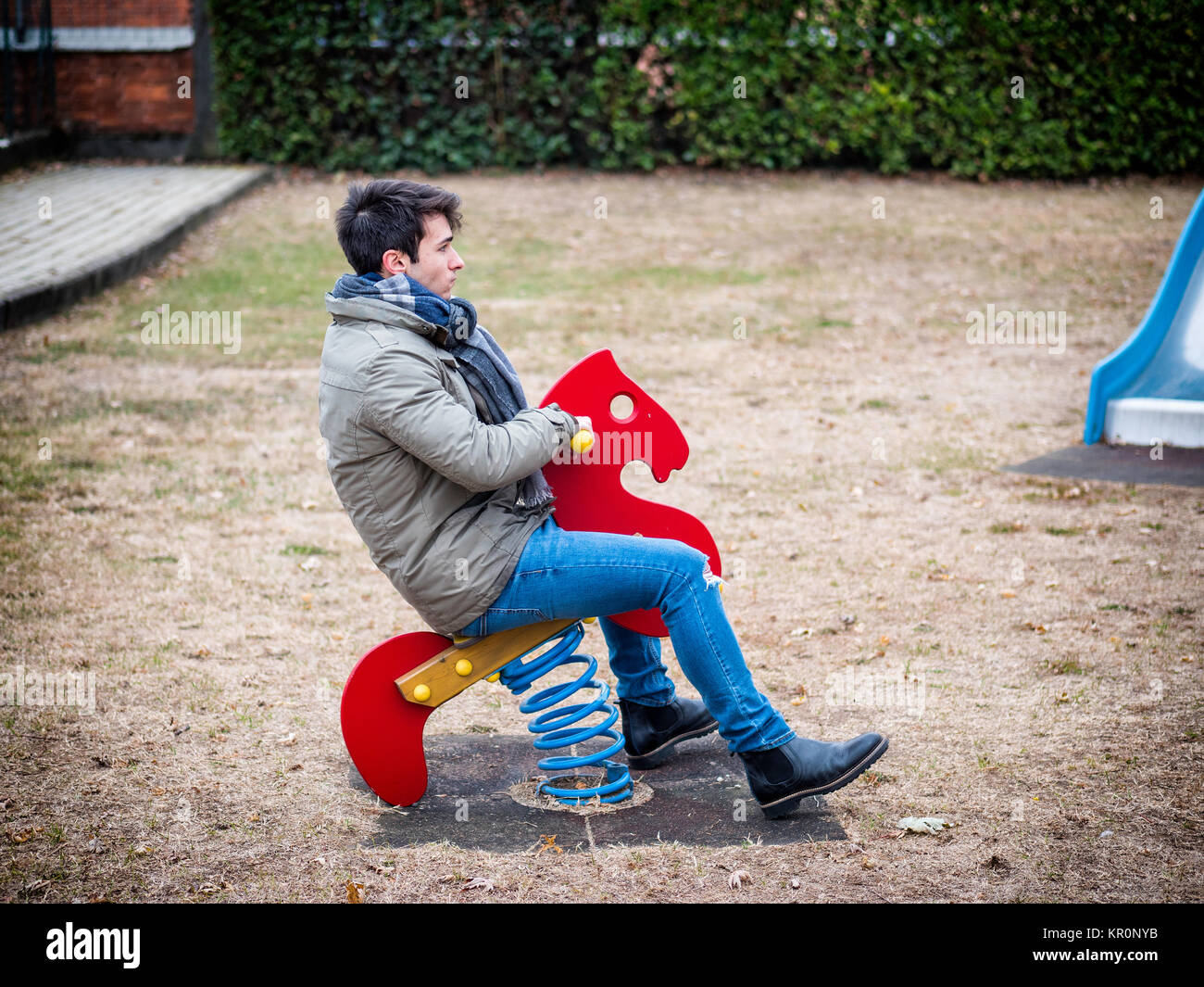 Young man reliving his childhood Stock Photo - Alamy