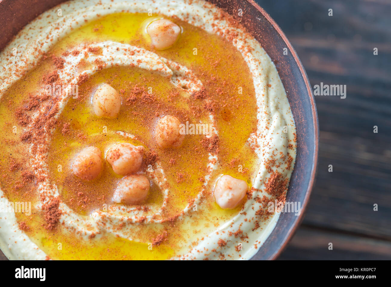 Bowl of hummus on the wooden table Stock Photo - Alamy
