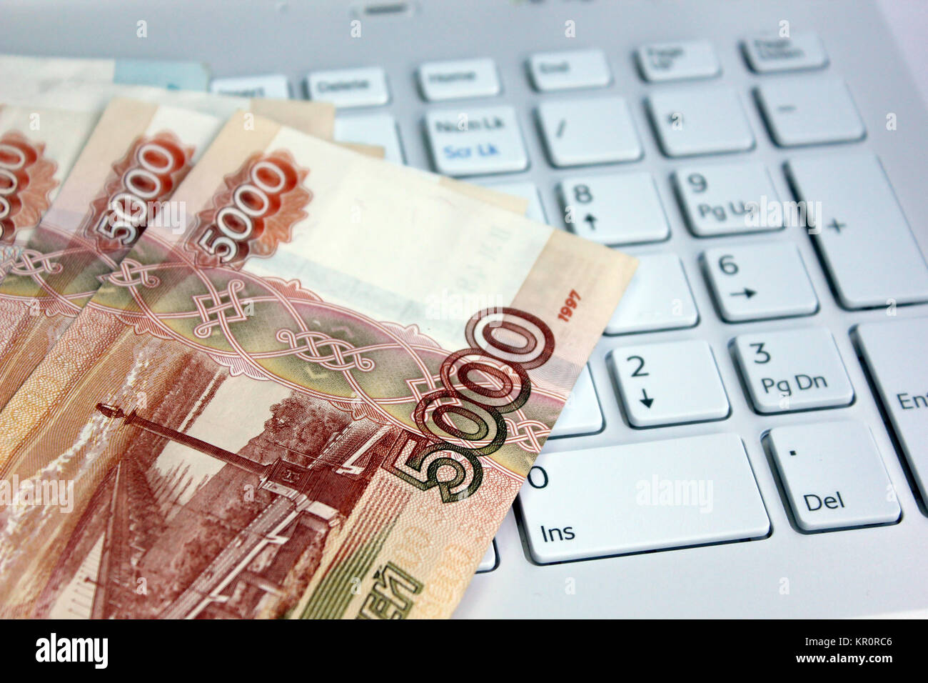 Money for the computer Stock Photo - Alamy
