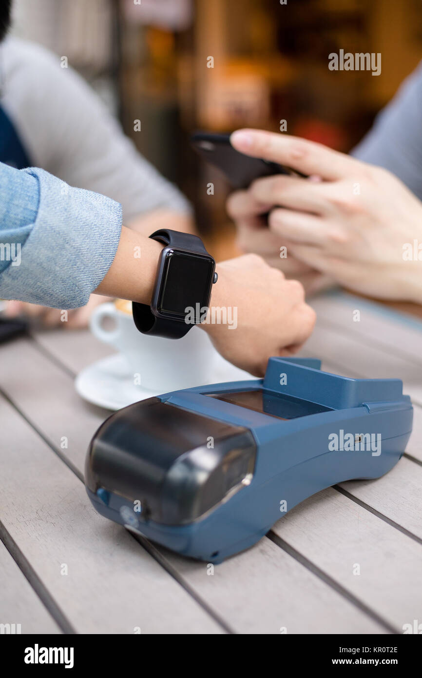 Customer pay with smartwatch Stock Photo - Alamy