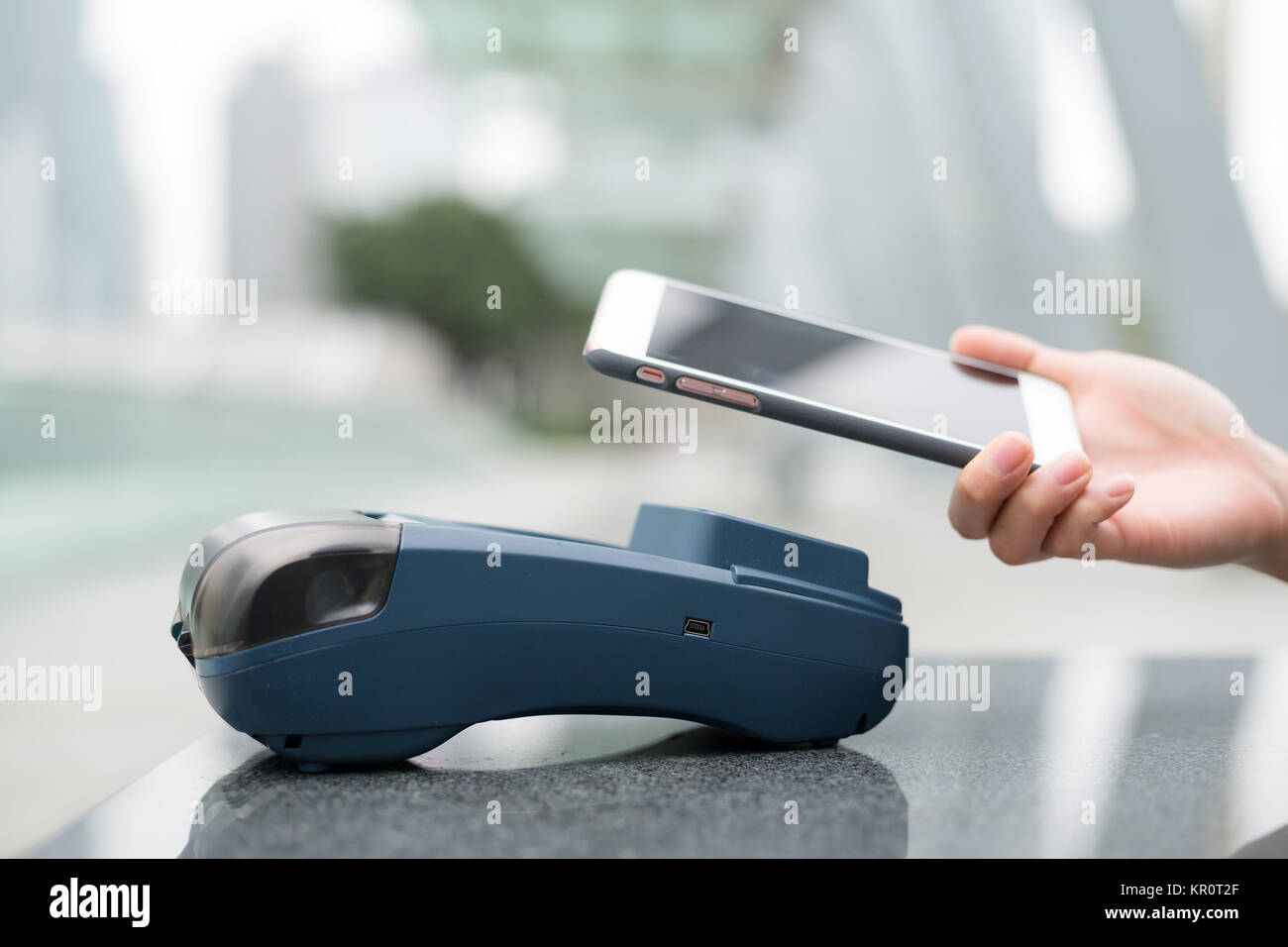 Customer pay with cellphone on pos terminal Stock Photo - Alamy