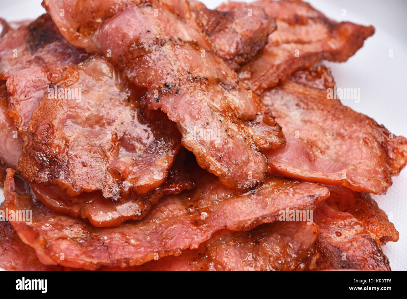 Crispy fried bacon slices cooked on bbq grill Stock Photo - Alamy