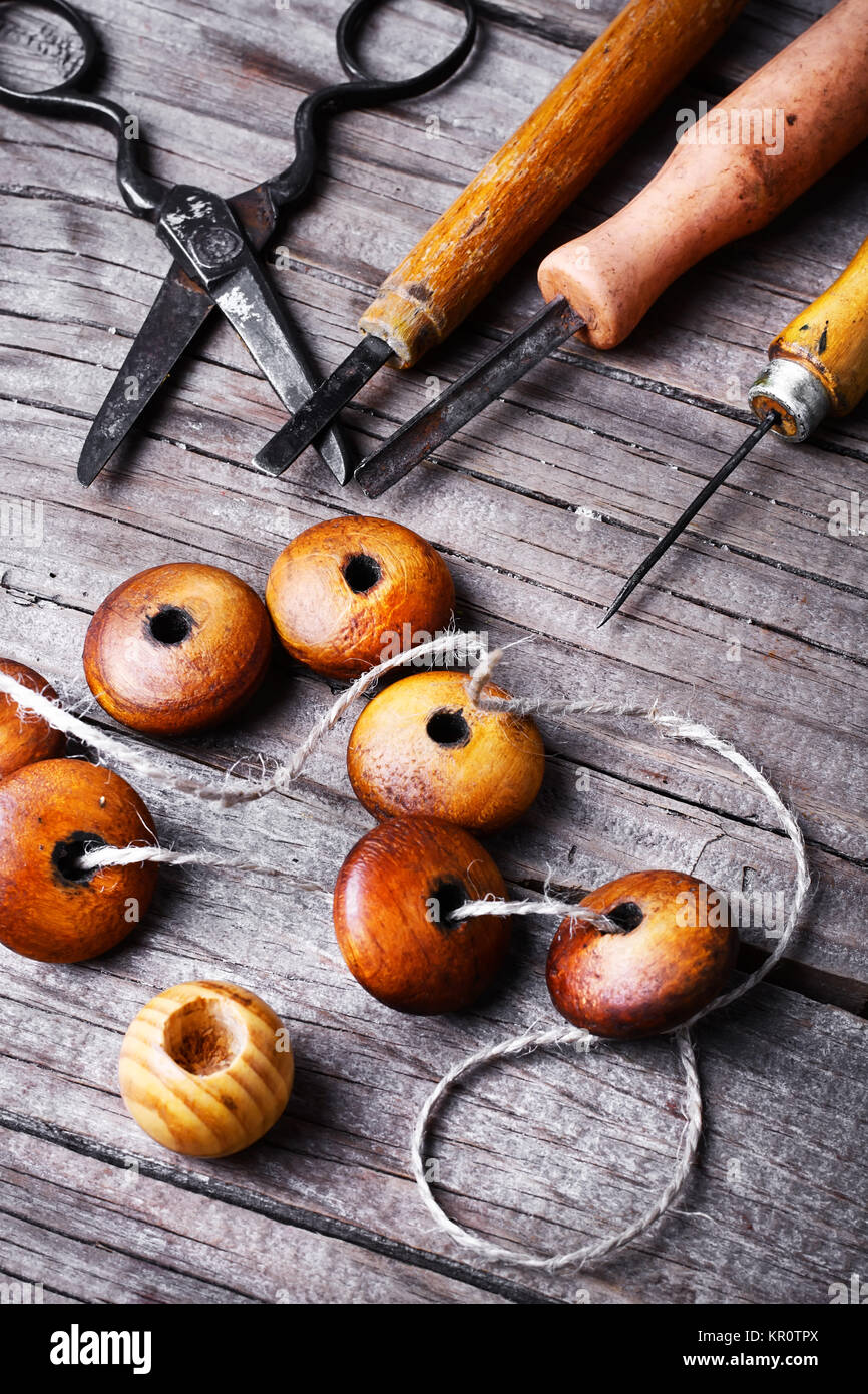 Accessories craft with wooden beads and tools on wooden background ...