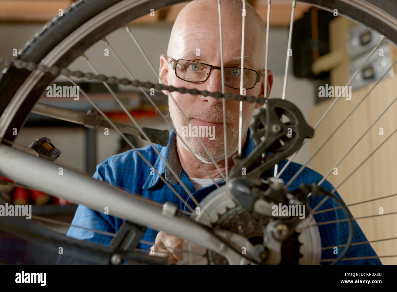 man repairing bike gear in his workshop Stock Photo - Alamy