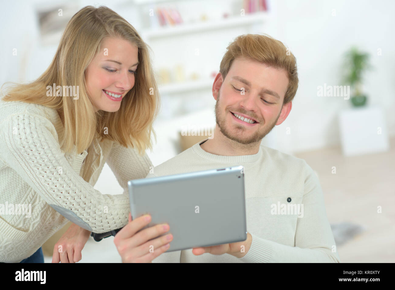 Couple browsing the internet together Stock Photo - Alamy