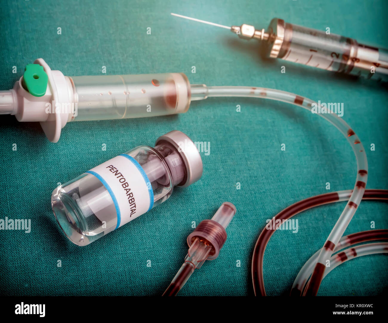 Rubber drip irrigation system with traces of blood along with vial of ...