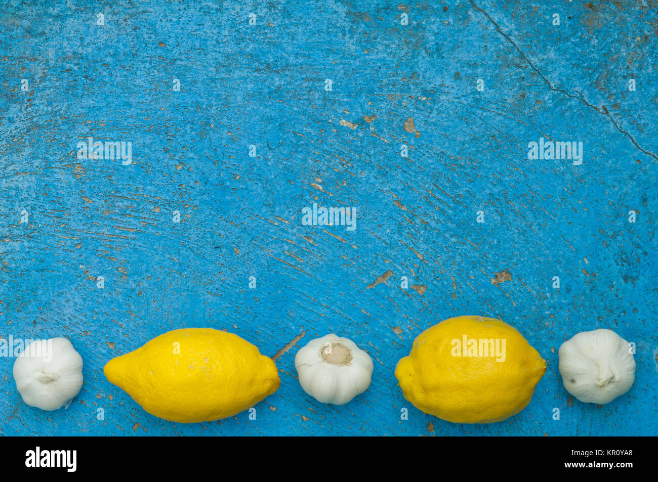 Old light blue textured background with lemon and garlic turquoise ...