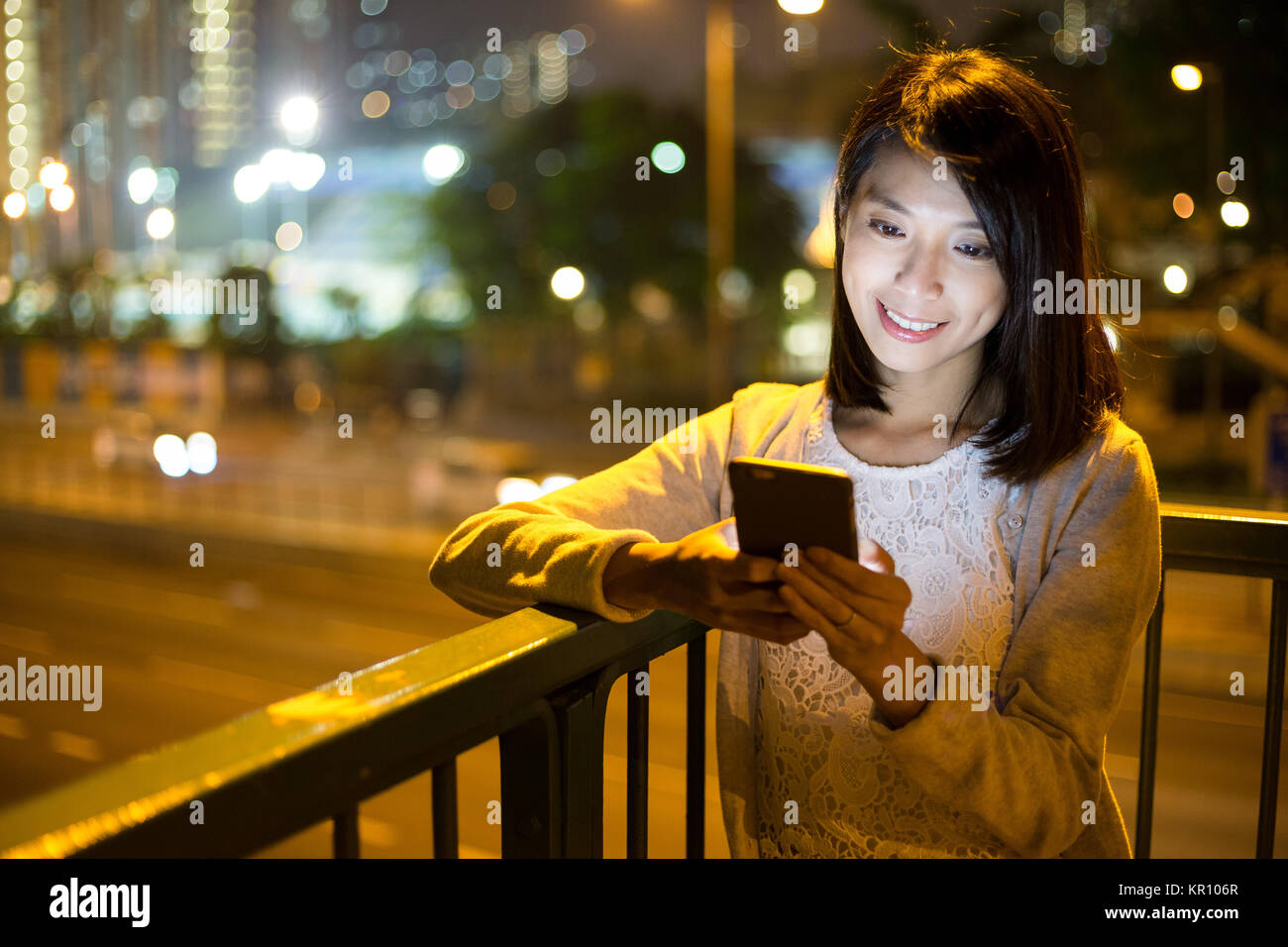 Woman use of mobile phone at night Stock Photo - Alamy