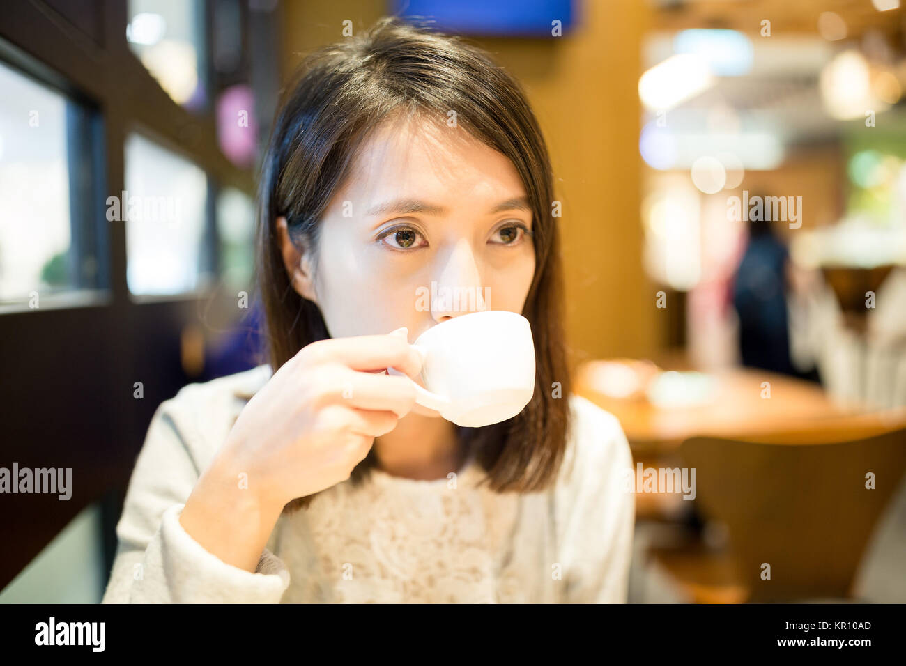 Woman drink coffee at cafe Stock Photo - Alamy