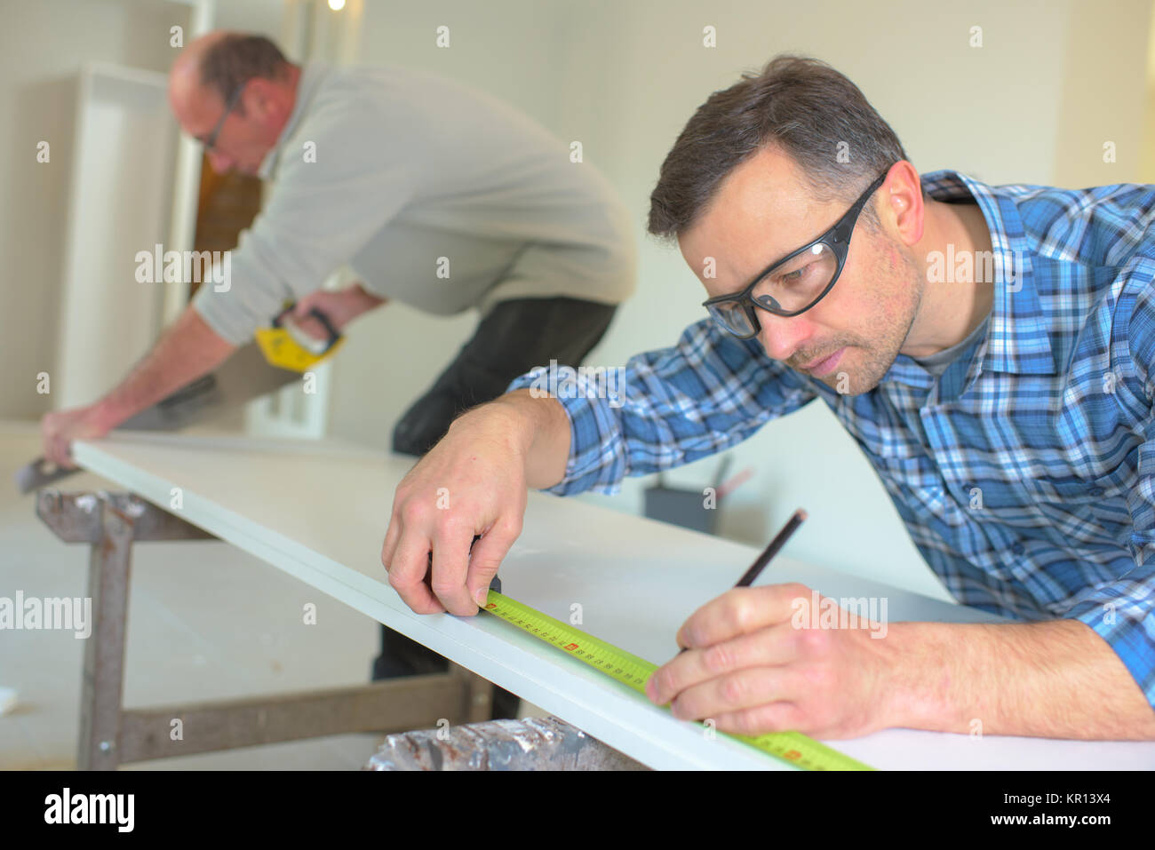 Measuring plank of wood Stock Photo - Alamy