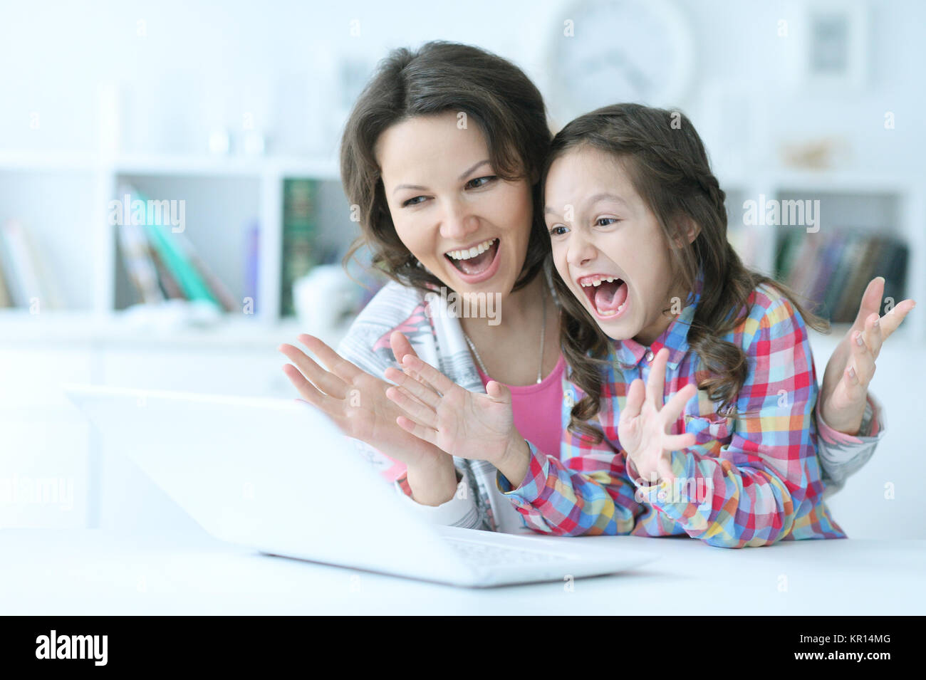 mother and daughter using laptop Stock Photo - Alamy