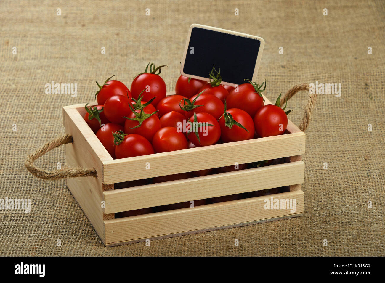 Red tomatoes in box with price sign over canvas Stock Photo - Alamy