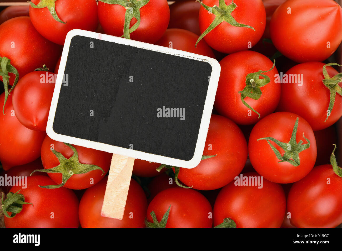 Red cherry tomatoes with black price sign Stock Photo - Alamy
