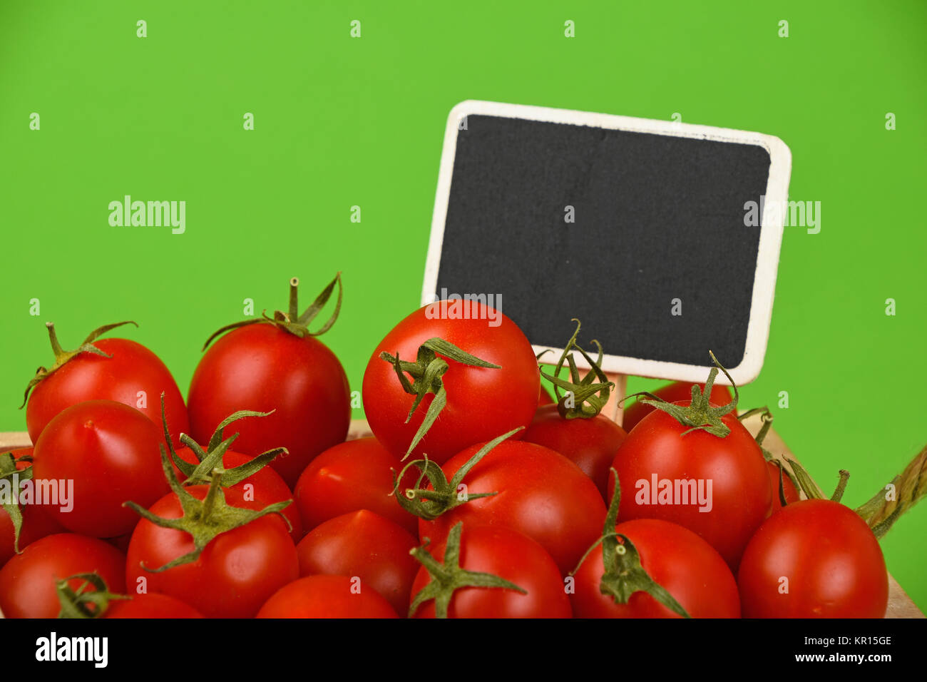 Red tomatoes with price sign over green Stock Photo - Alamy