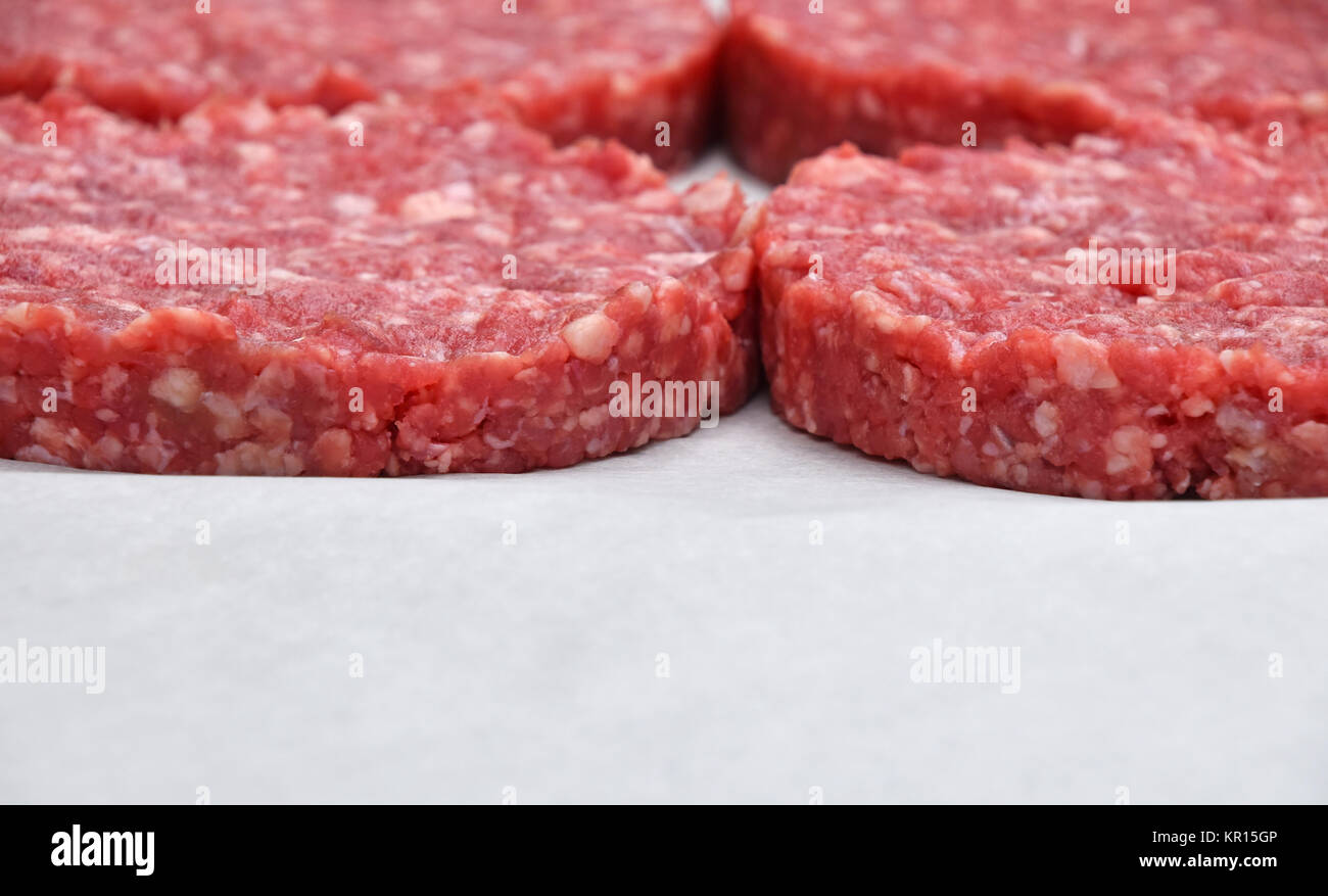 Raw meat burgers for hamburgers on parchment Stock Photo - Alamy