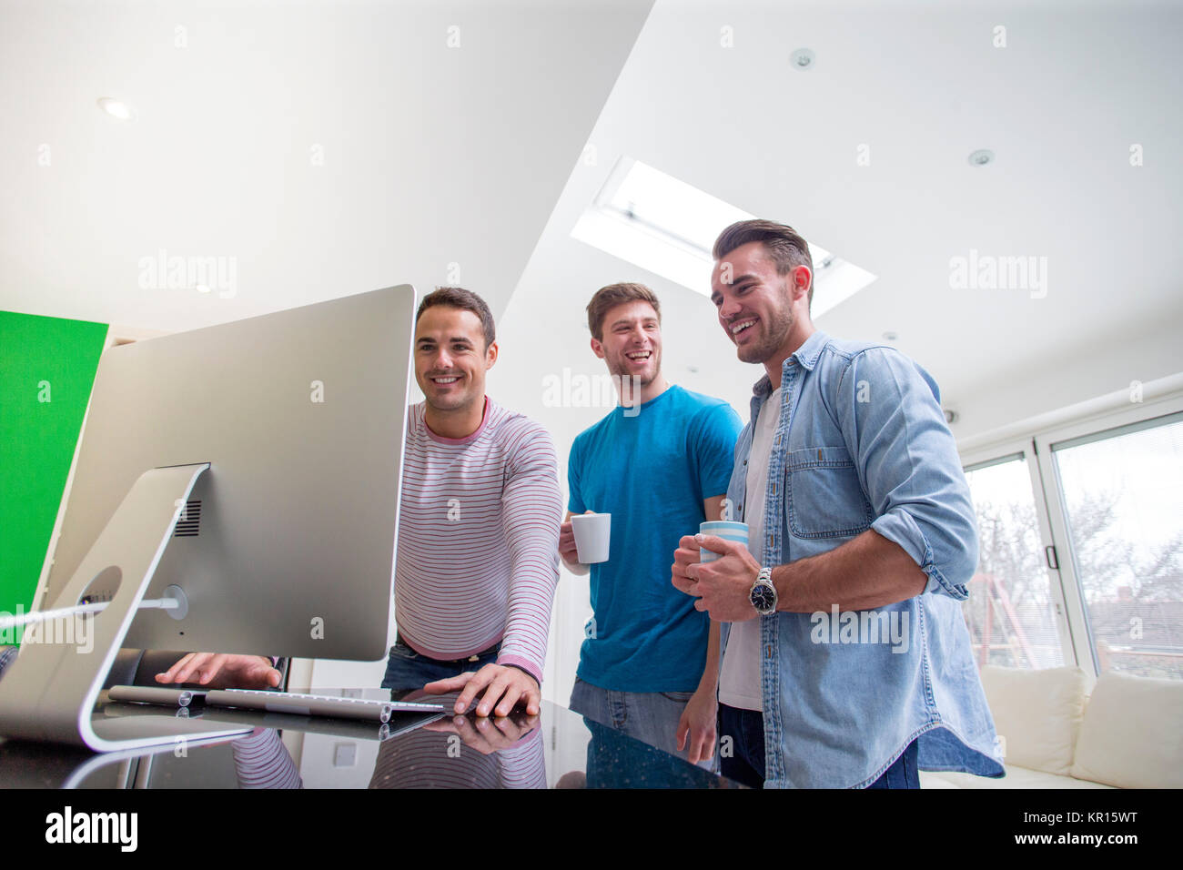 Friends Gathered Around Computer Stock Photo - Alamy