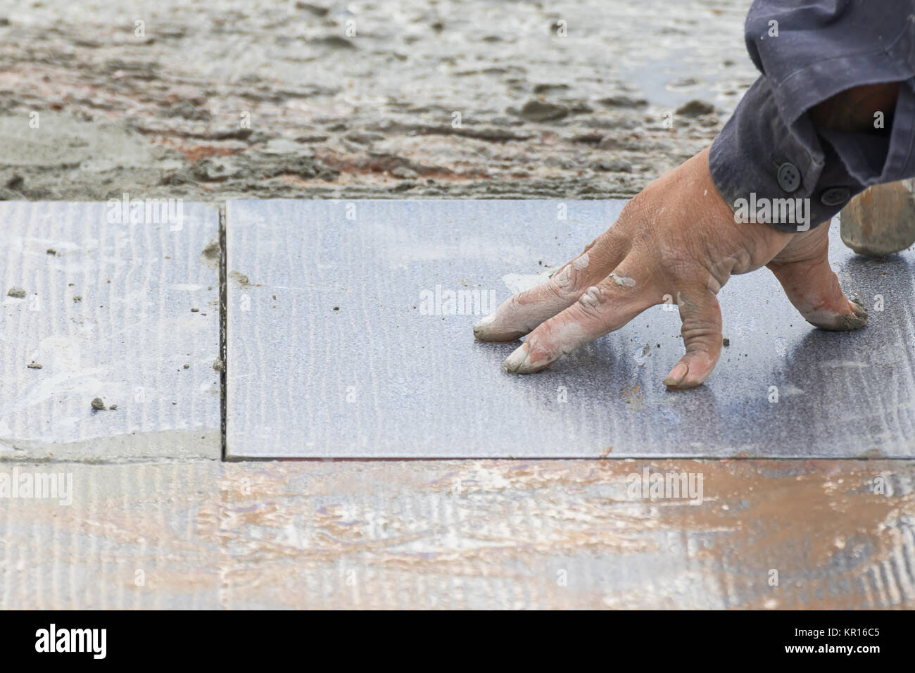Mason repairing the tiles Stock Photo - Alamy