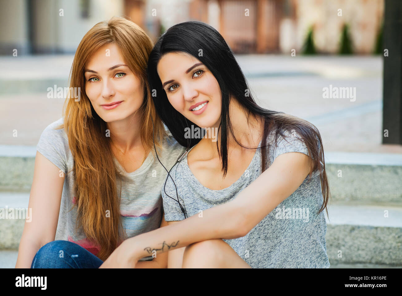 Two sisters sitting on stairs hi-res stock photography and images - Alamy