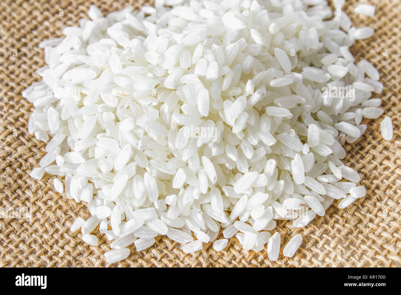 Grains of raw white rice on a white wooden table of boards. Ingredients ...