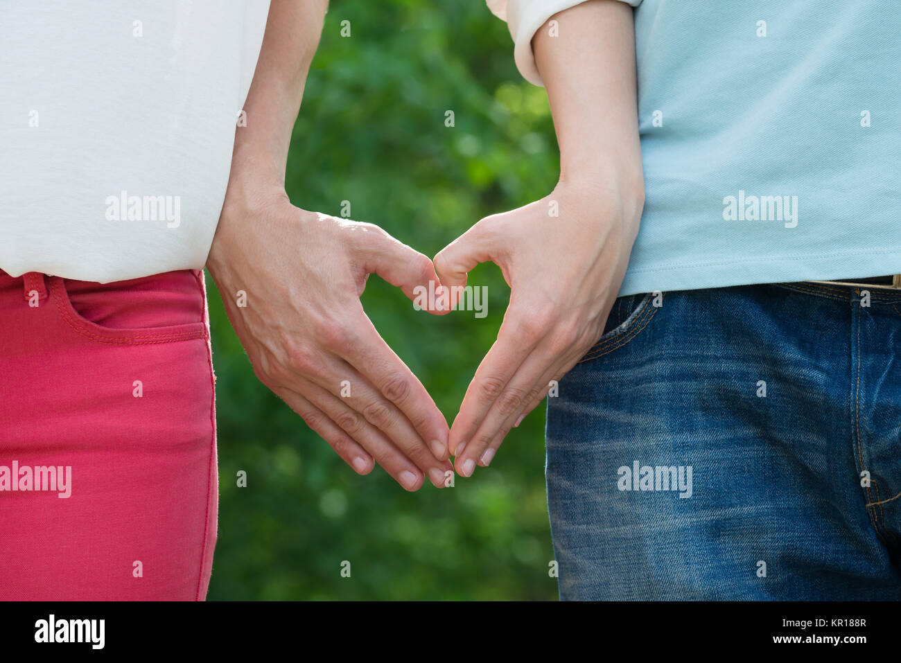 Couple Making Heart Shape Stock Photo - Alamy