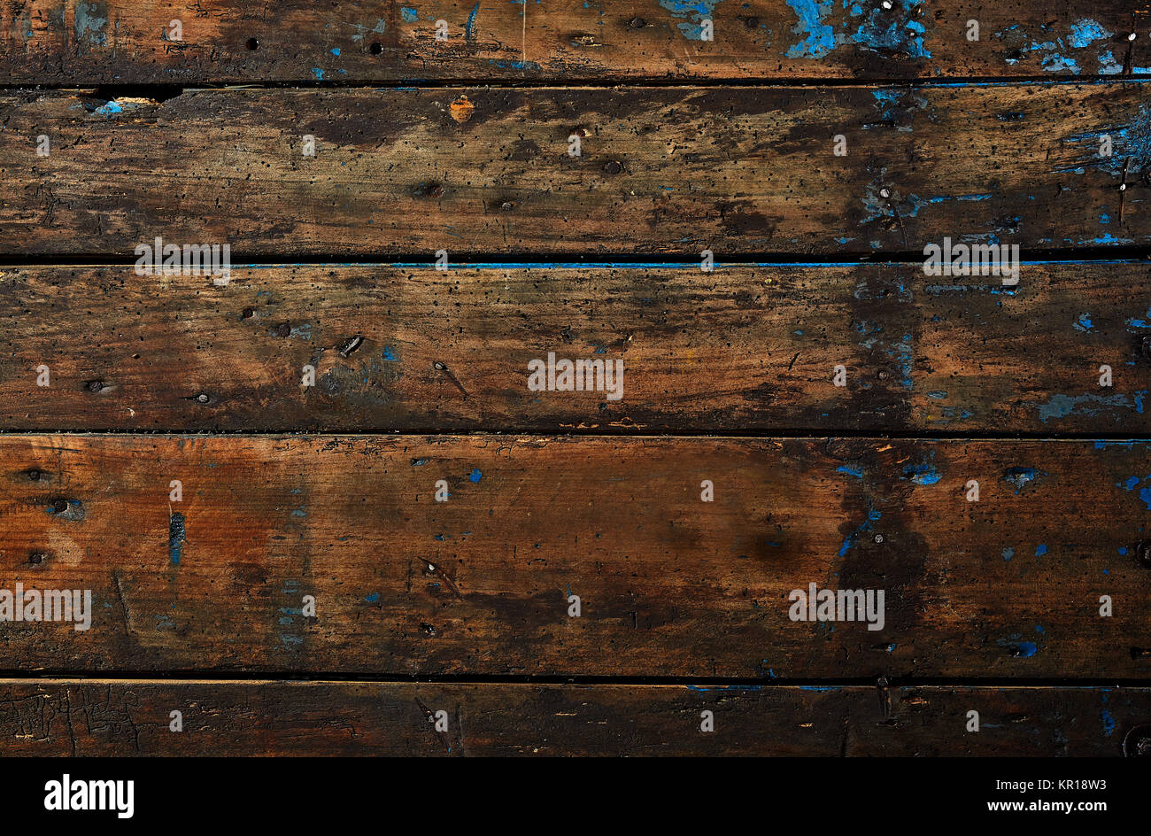 Old dark vintage wood background texture with dents and stains in a ...