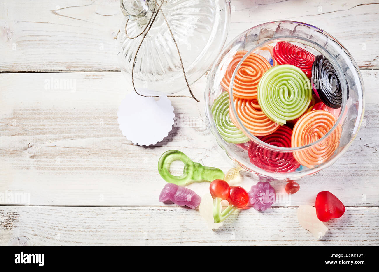 Overhead close up view of licorice rolls in open glass jar and besides ...