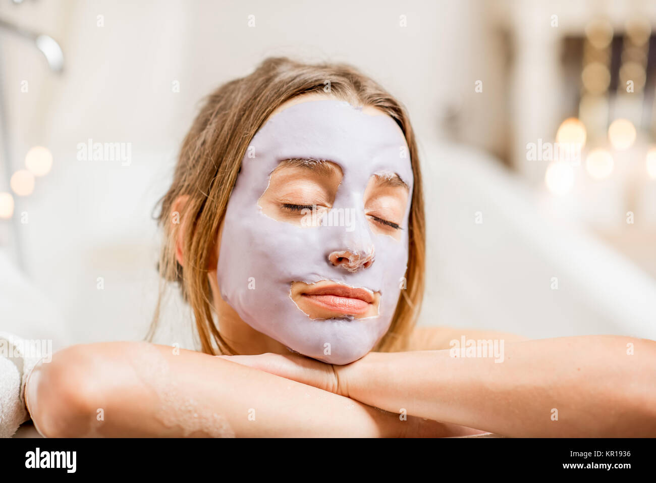 Woman with facial mask in the bathroom Stock Photo - Alamy
