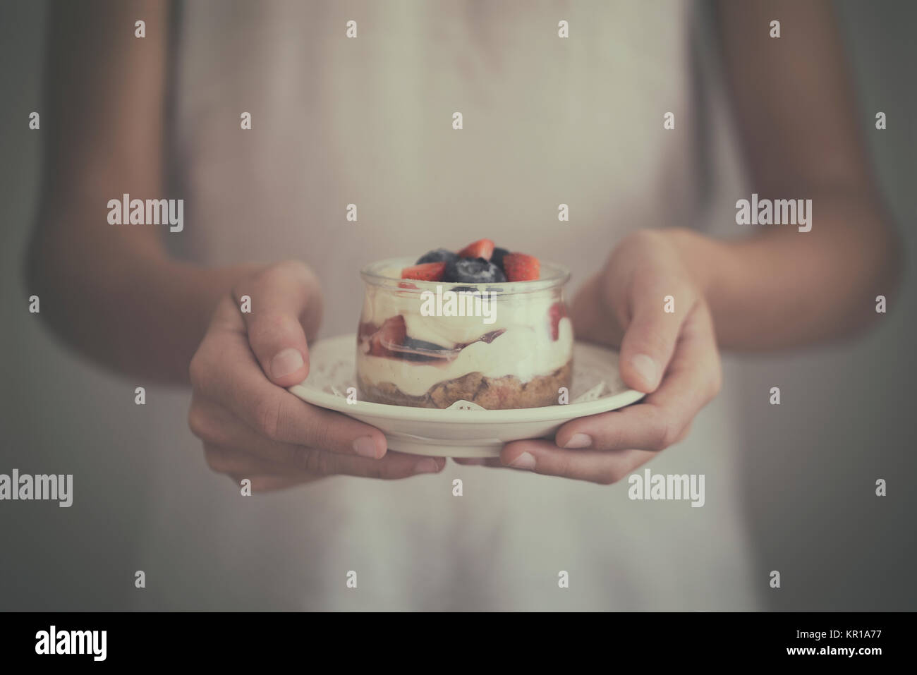 Boy carrying a fruit dessert Stock Photo - Alamy