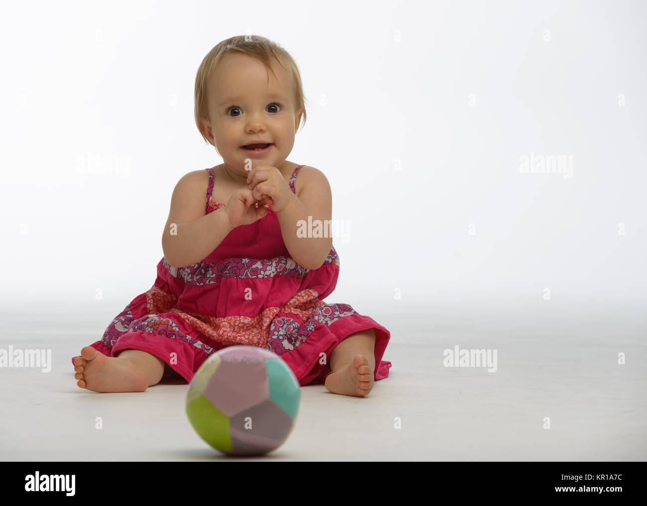Baby girl playing with a toy ball Stock Photo - Alamy