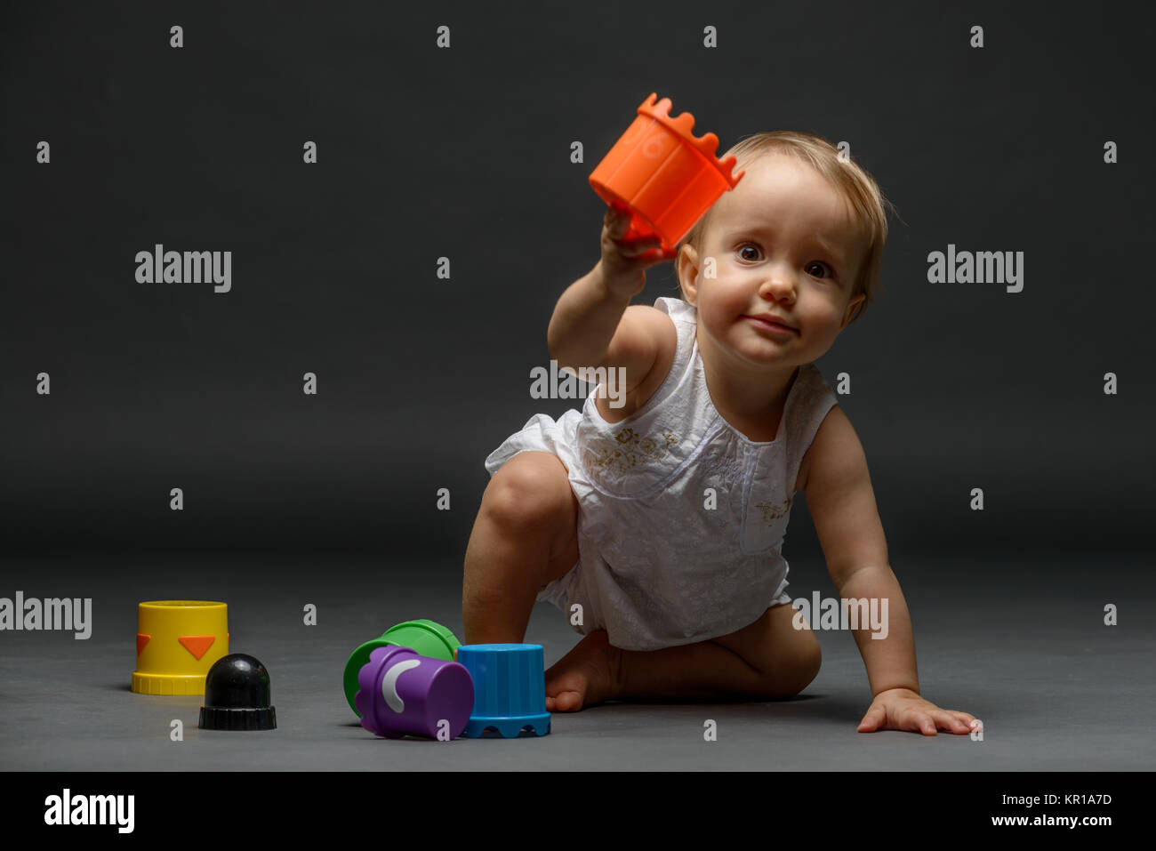 Baby girl playing with toys Stock Photo - Alamy