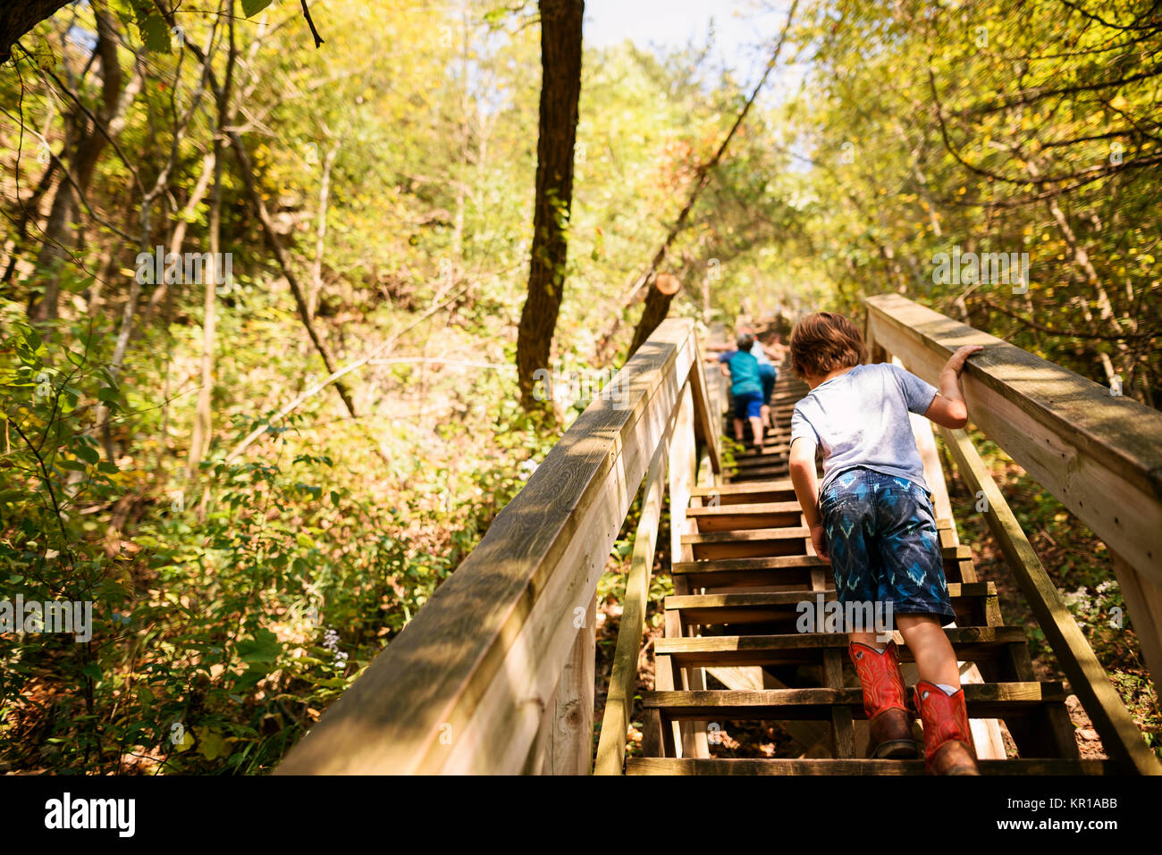 Boy walking up stairs hi-res stock photography and images - Alamy