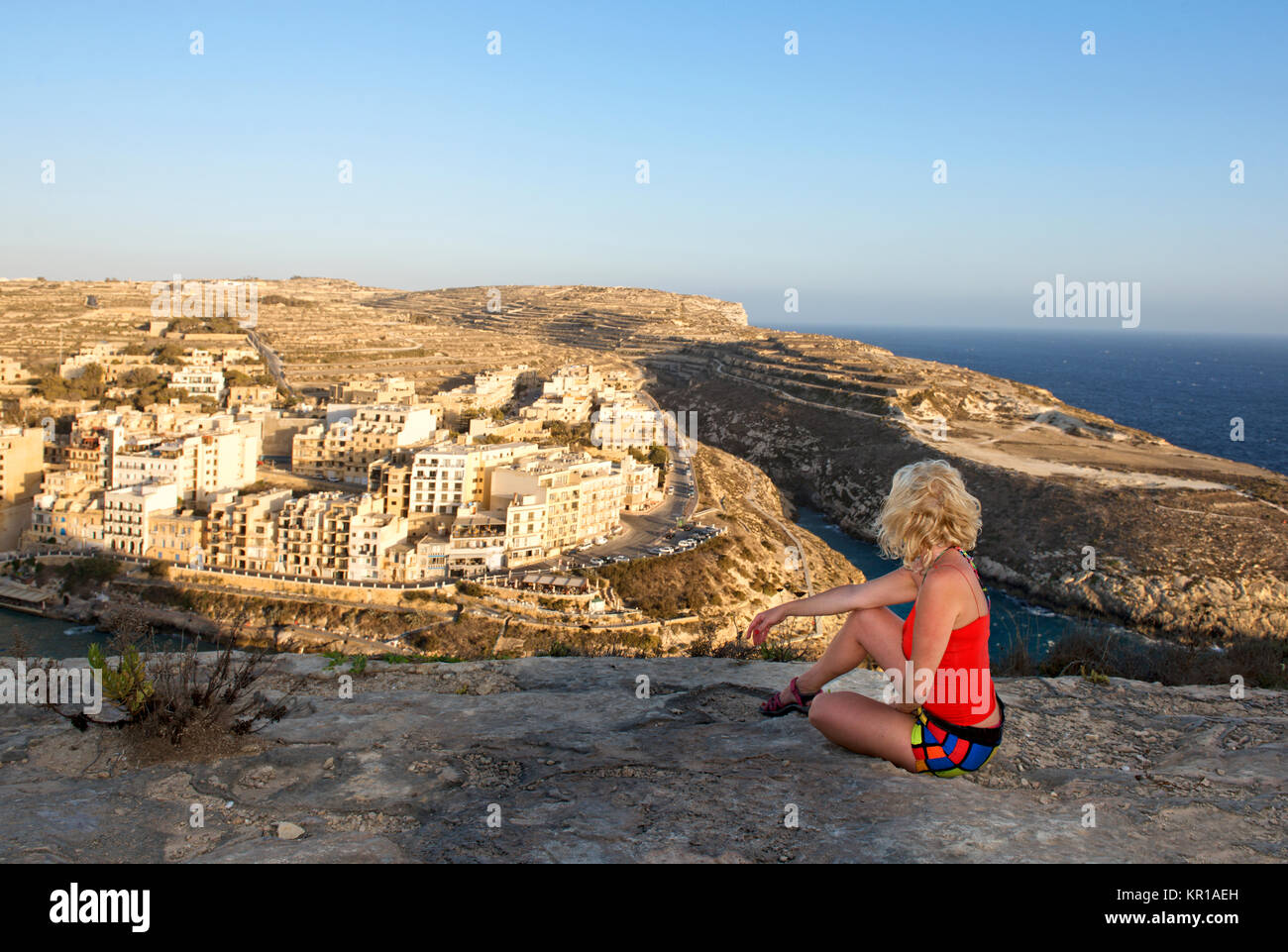 Woman sitting on a hill, Xlendi, Gozo island, Malta Stock Photo - Alamy