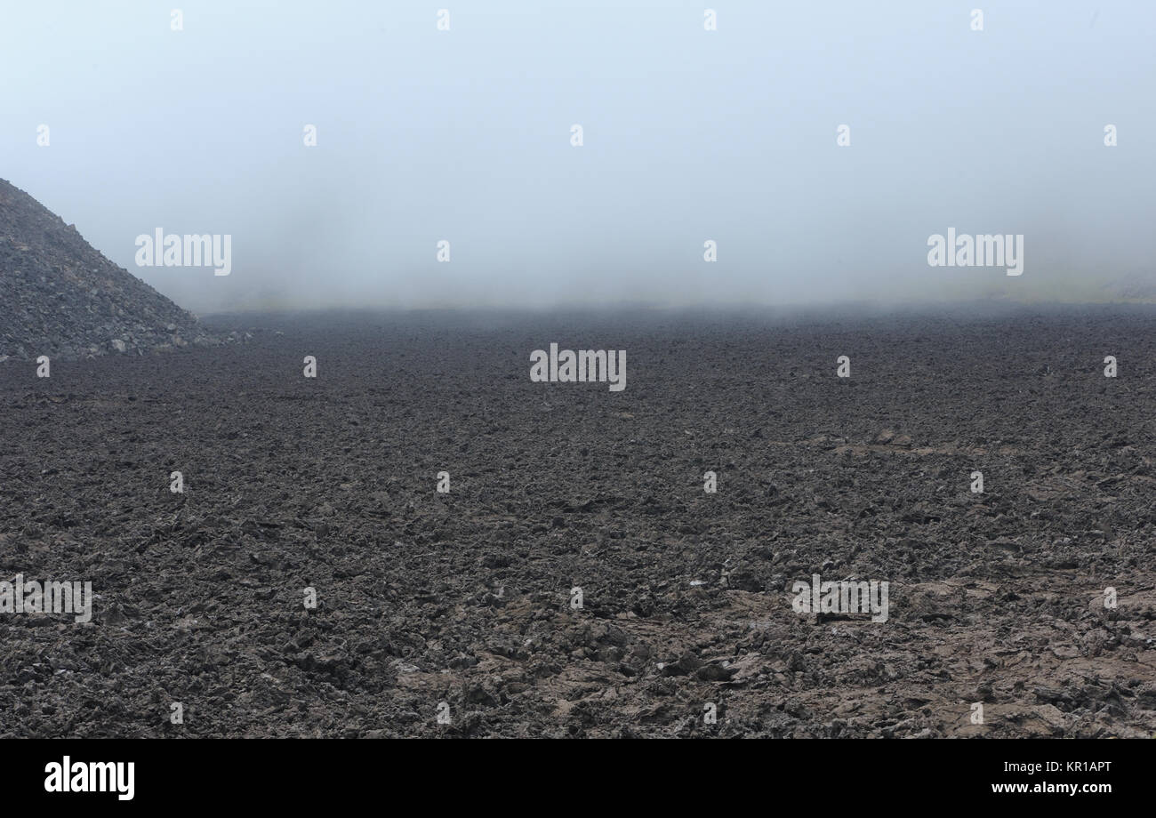Cloud pours down the rim of the Sierra Negra Volcano and flows over the ...