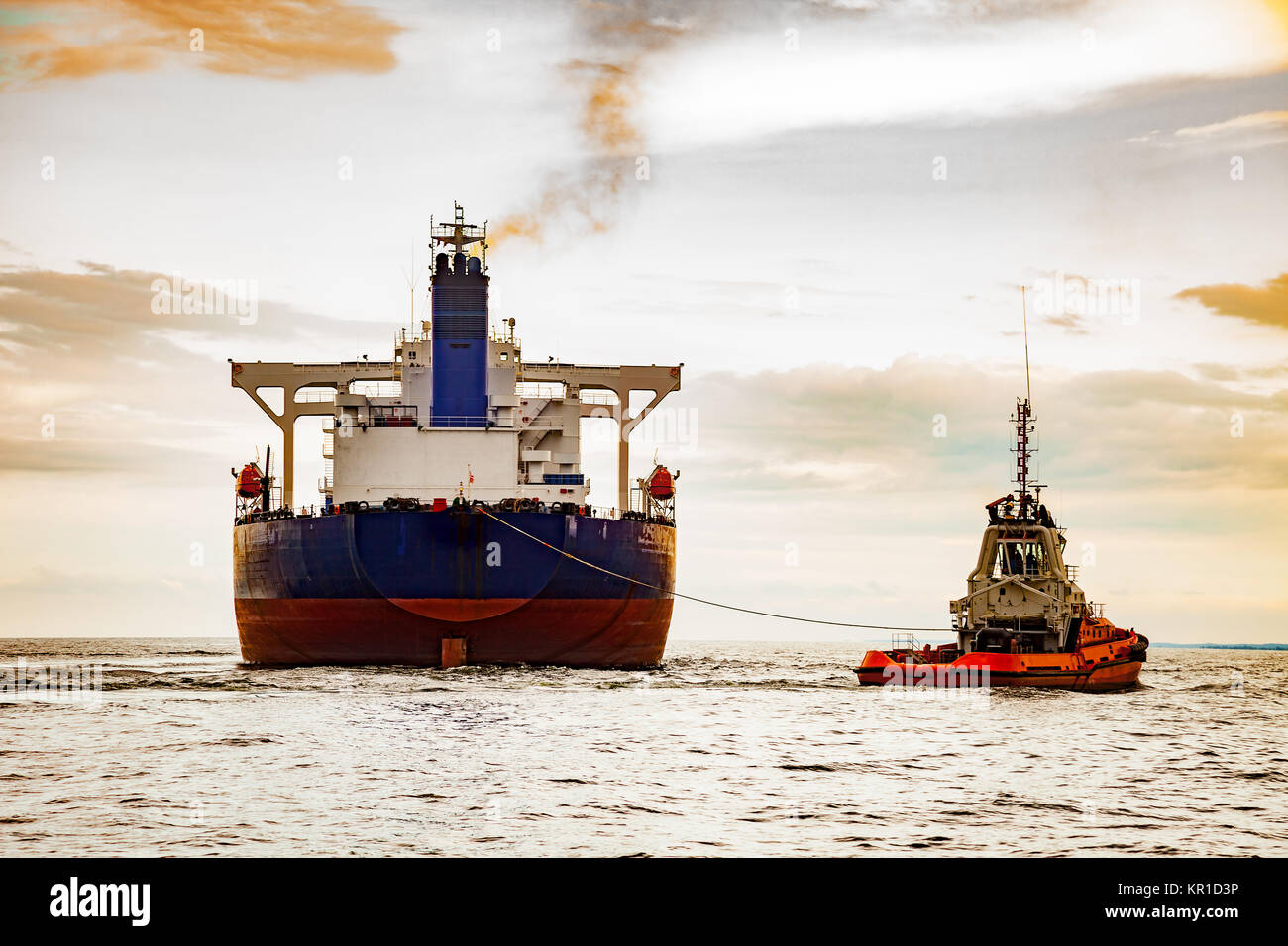 Tug boat towing a tanker ship at sea Stock Photo - Alamy