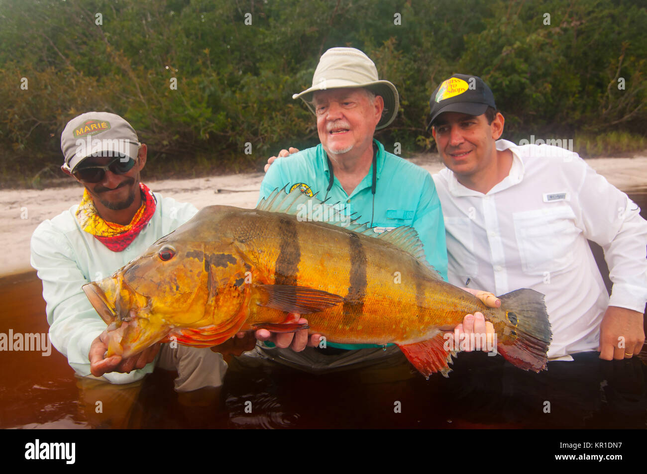 A happy angler and his guide and fishing partner pose for a quick photo ...