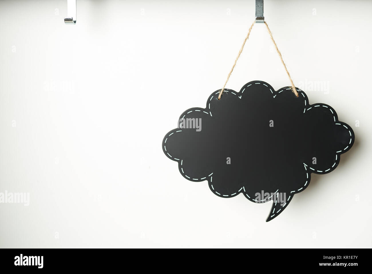 Cloud tag for text hanging on hook white background Stock Photo - Alamy