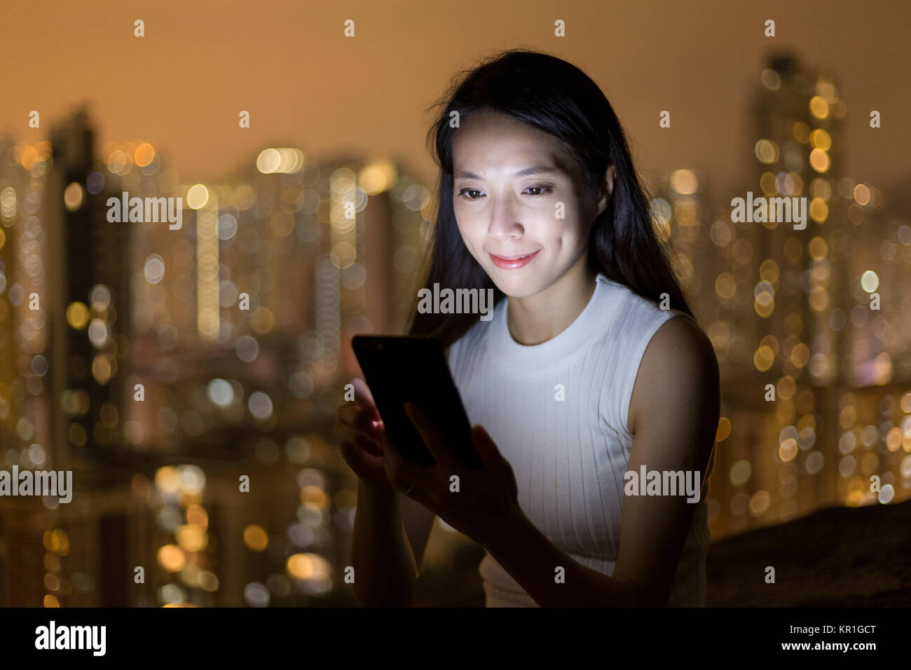 Woman use of cellphone at night Stock Photo - Alamy