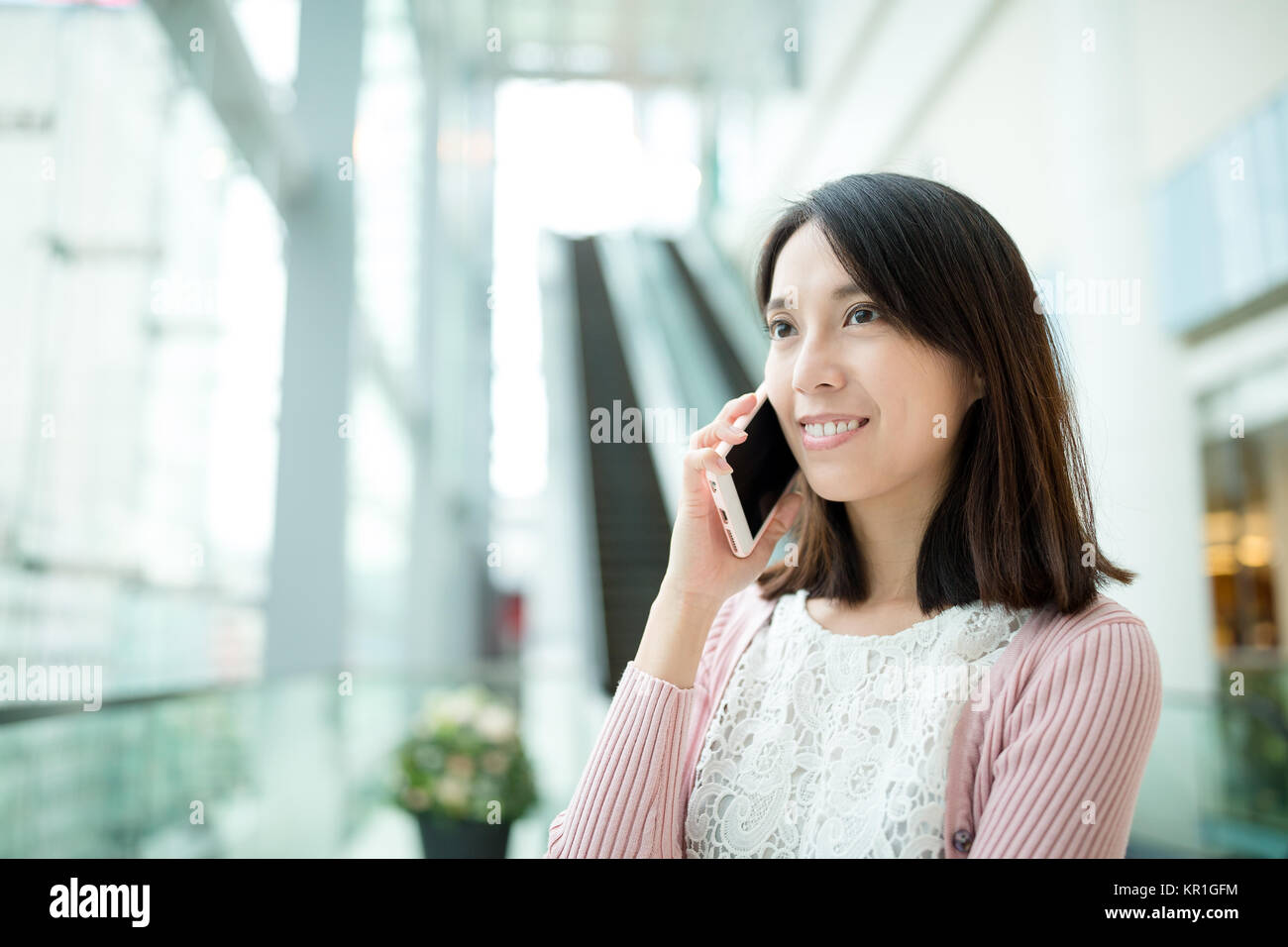 Woman talk to mobile phone in shopping mall Stock Photo - Alamy