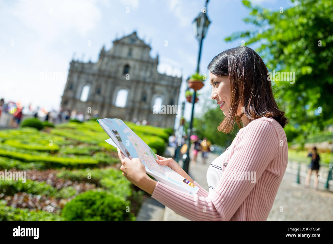 Woman checking on city map Stock Photo - Alamy