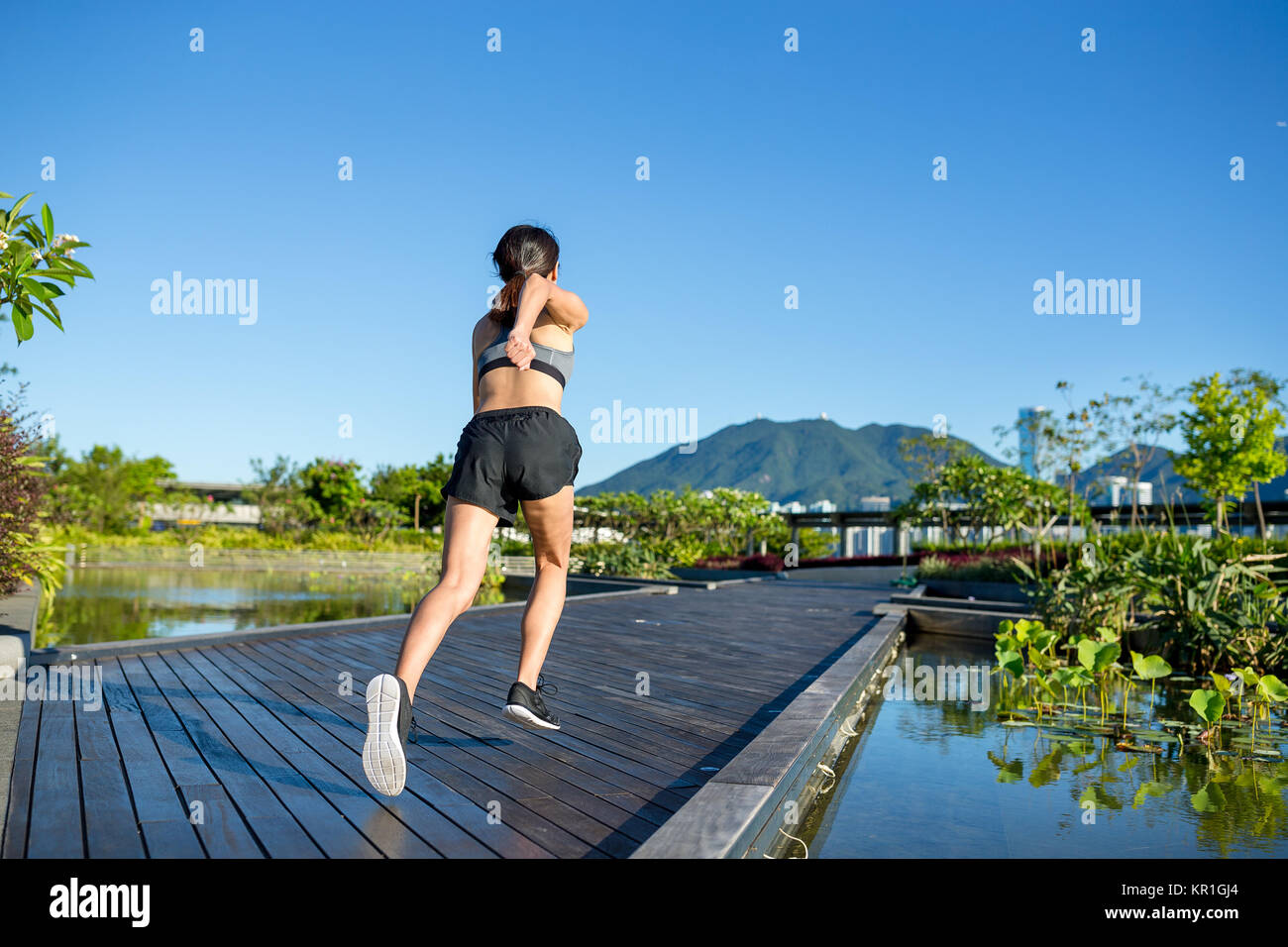 Runner athlete running at park Stock Photo - Alamy