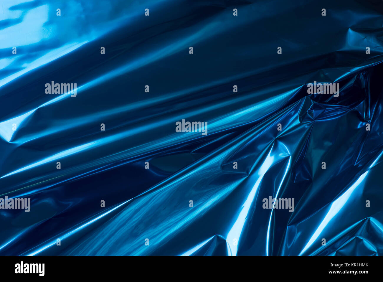 blue color folded metallic foil abstract bacgkground Stock Photo - Alamy